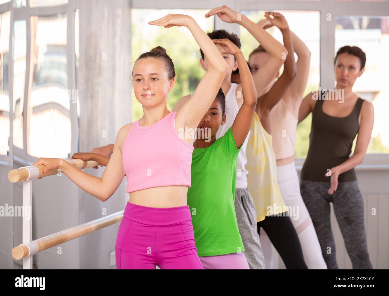Teenage girl practicing ballet positions in dance studio Stock Photo ...