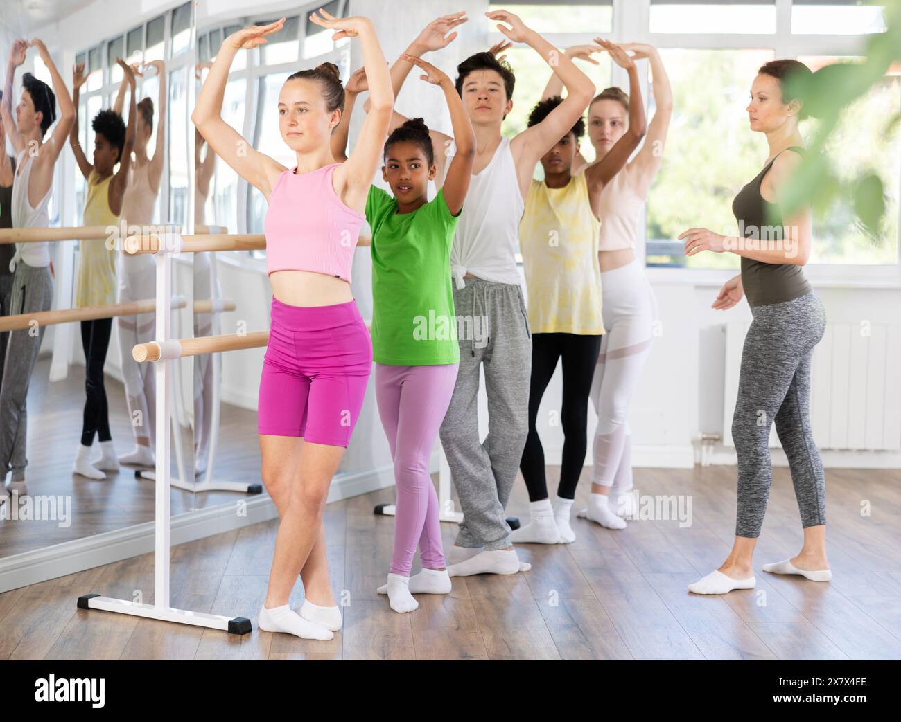 Teen girl mastering fifth position in beginner ballet class Stock Photo ...