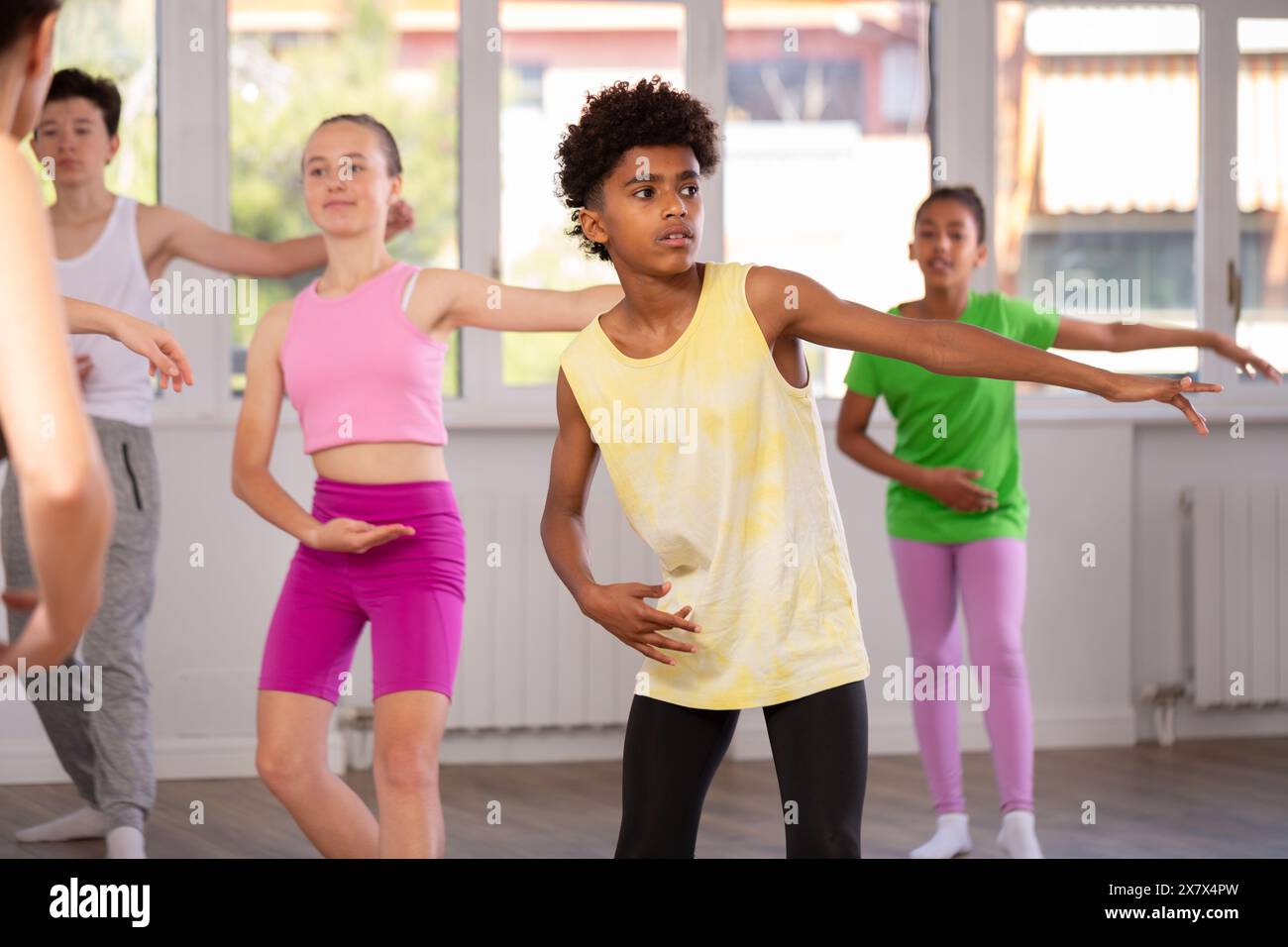 African american teen boy participating in beginner group ballet class ...