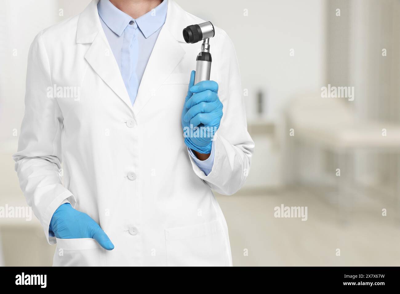 Professional dermatologist with dermatoscope on blurred background ...