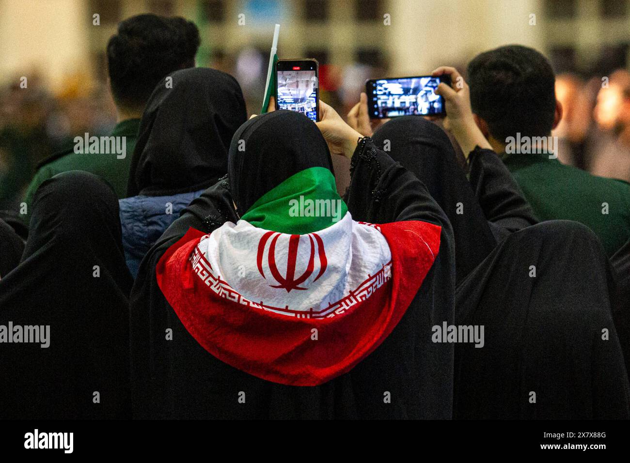Iranian officials adjust the coffin of late President Ebrahim Raisi ...