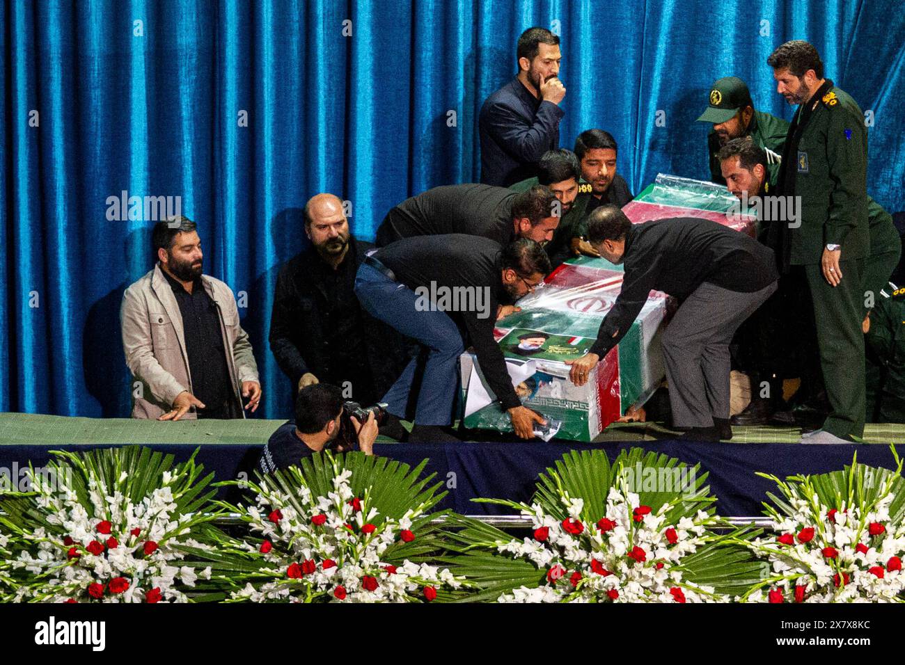 Iranian officials adjust the coffin of late President Ebrahim Raisi ...