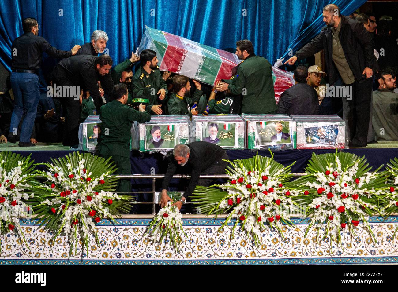 Iranian officials adjust the coffin of late President Ebrahim Raisi ...
