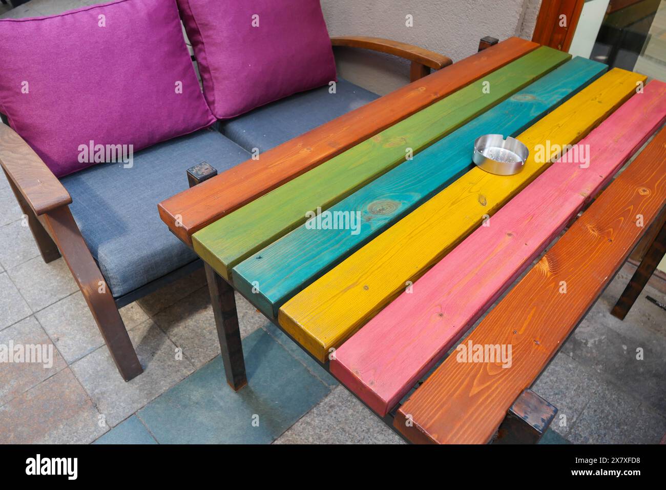 Rainbow wooden table outdoors with ashtray, hardwood and wood stain ...