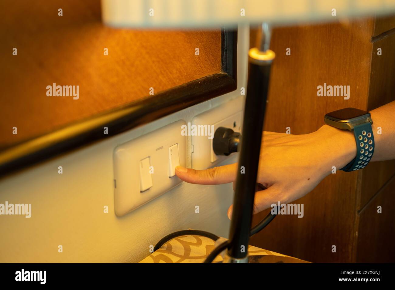 A woman's hand is pulling an electrical plug to turn off a switch. to ...