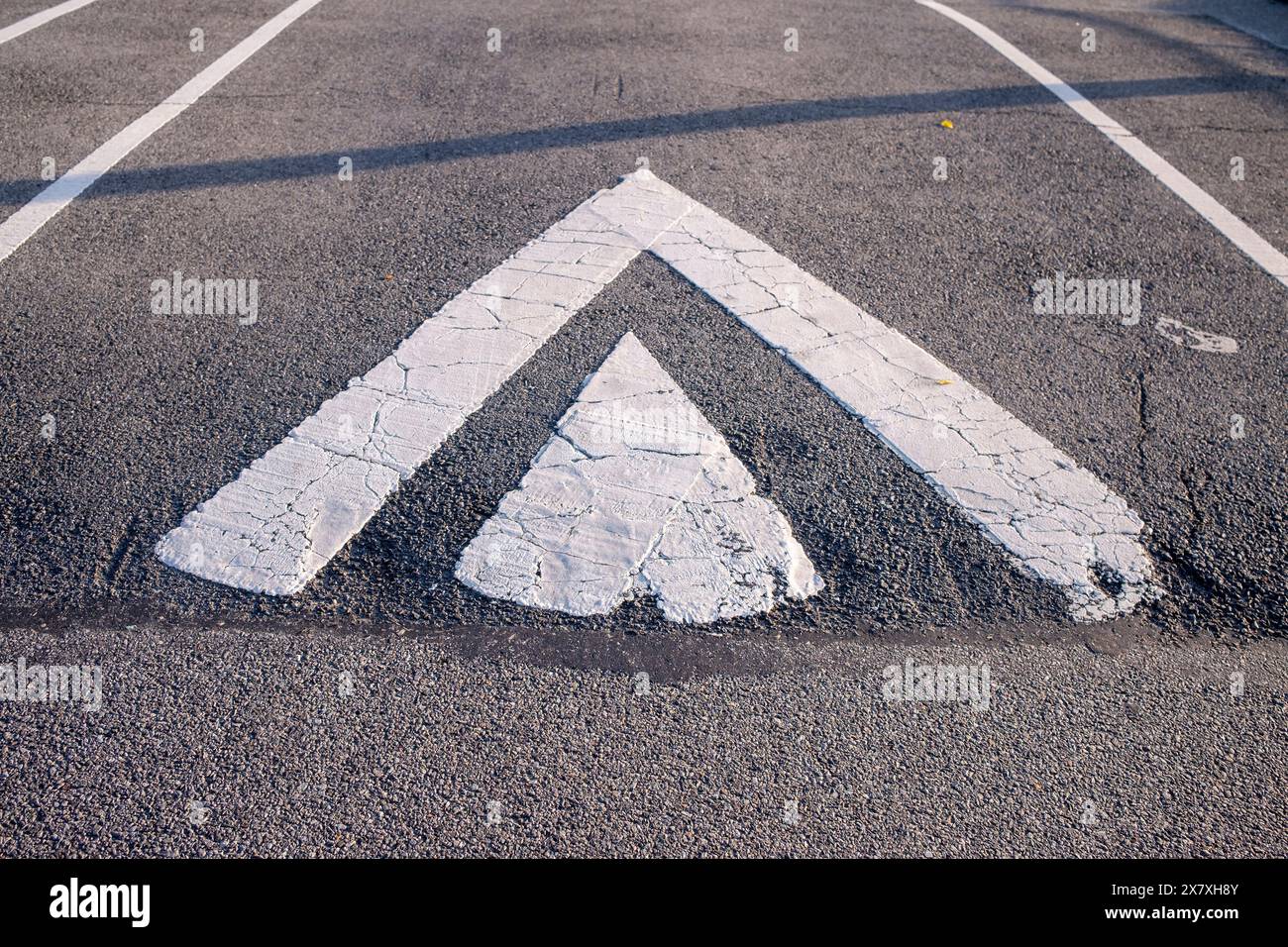Speed BUMP arrow painted for better visibility Stock Photo - Alamy