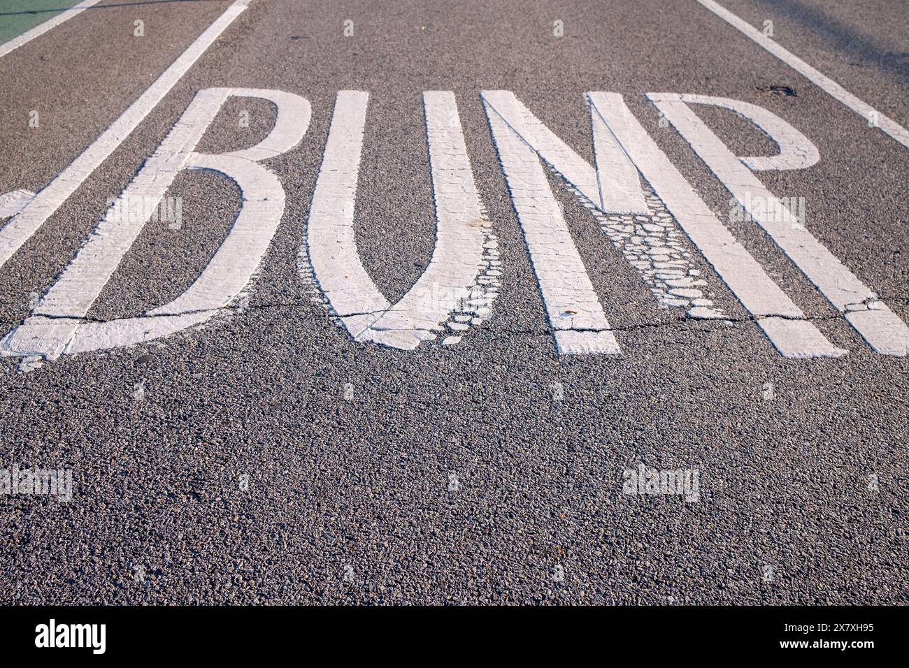 "BUMP" warning traffic sign painted on residential street surface Stock ...