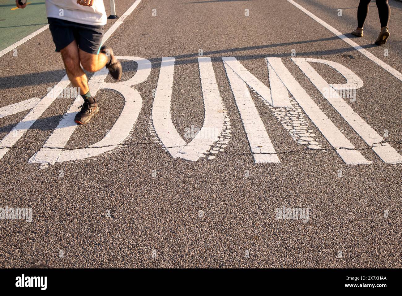 "BUMP" warning traffic sign painted on residential street surface Stock ...