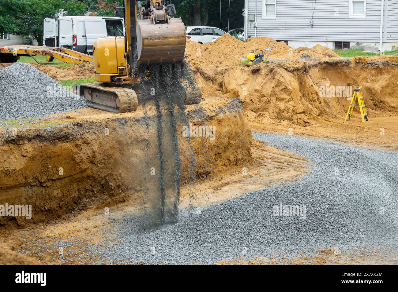 Excavators fill irregularities in excavations with granite rubble bases ...
