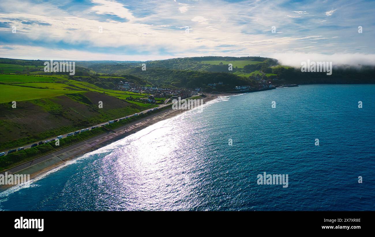 Aerial view of a coastal landscape with a road running parallel to the ...