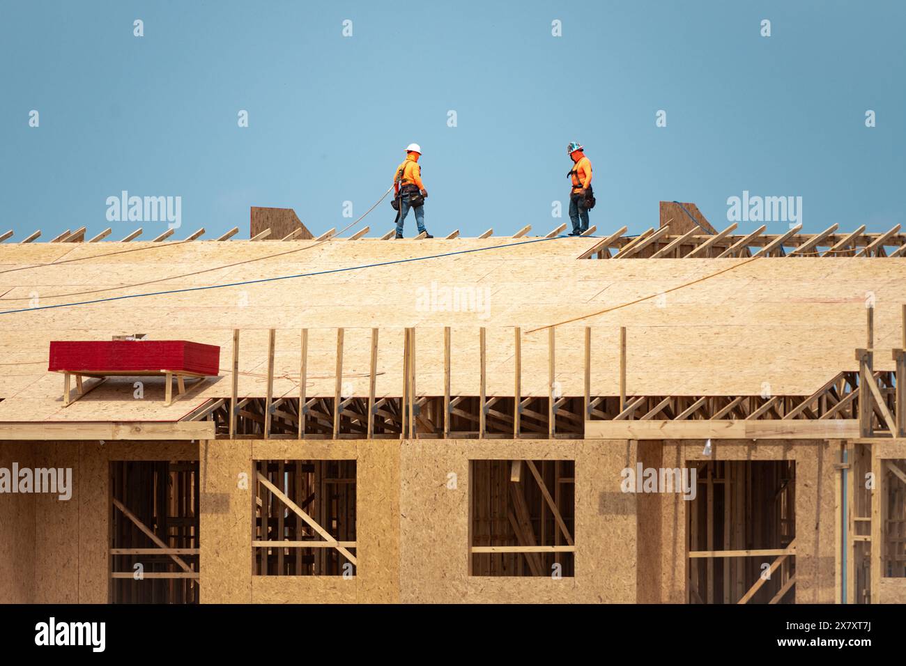 Wooden roof. Roofs repair. Roofer worker install new roof on top roof ...