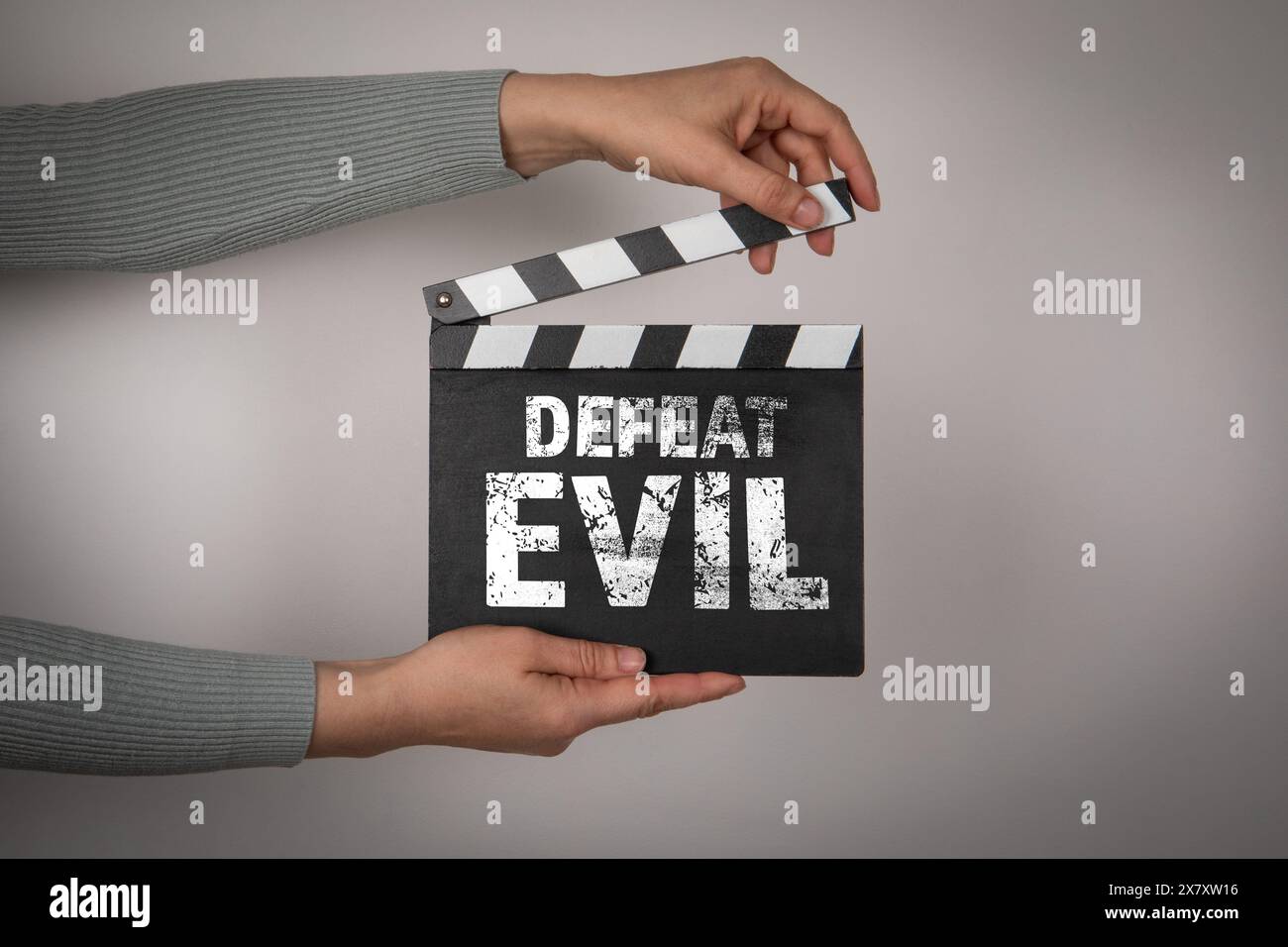 Defeat Evil. Politics Crime Health Concept. Female hands holding movie ...