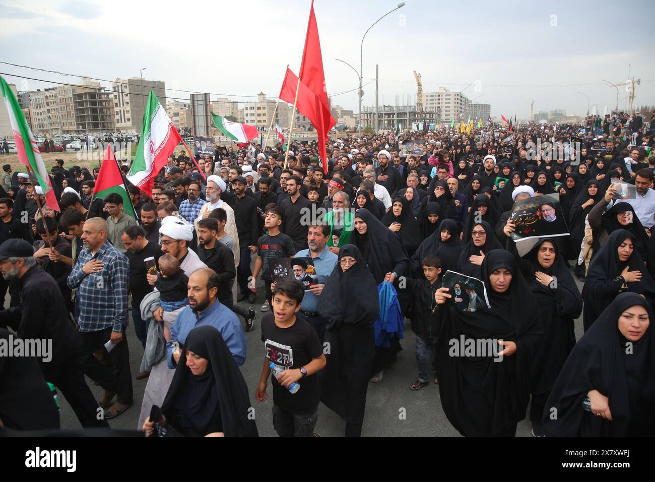 Qom, Iran. 21st May, 2024. People attend a funeral procession for the ...