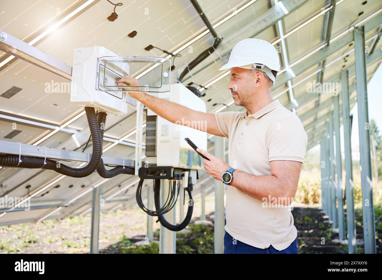 Male worker configuring solar panel according to instructions. Man ...