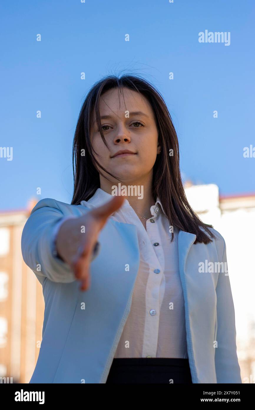 Vertical portrait of young businesswoman shaking hands Stock Photo - Alamy Vertical portrait of young businesswoman shaking hands Stock Photo - Alamy