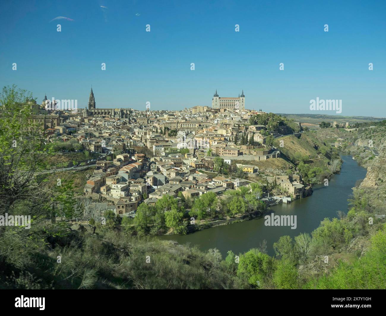 View of a historic riverside town with distinctive church towers and ...