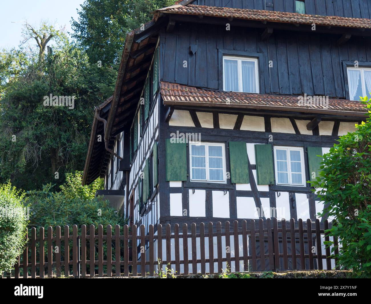 Traditional half-timbered house with black and white façade and green ...