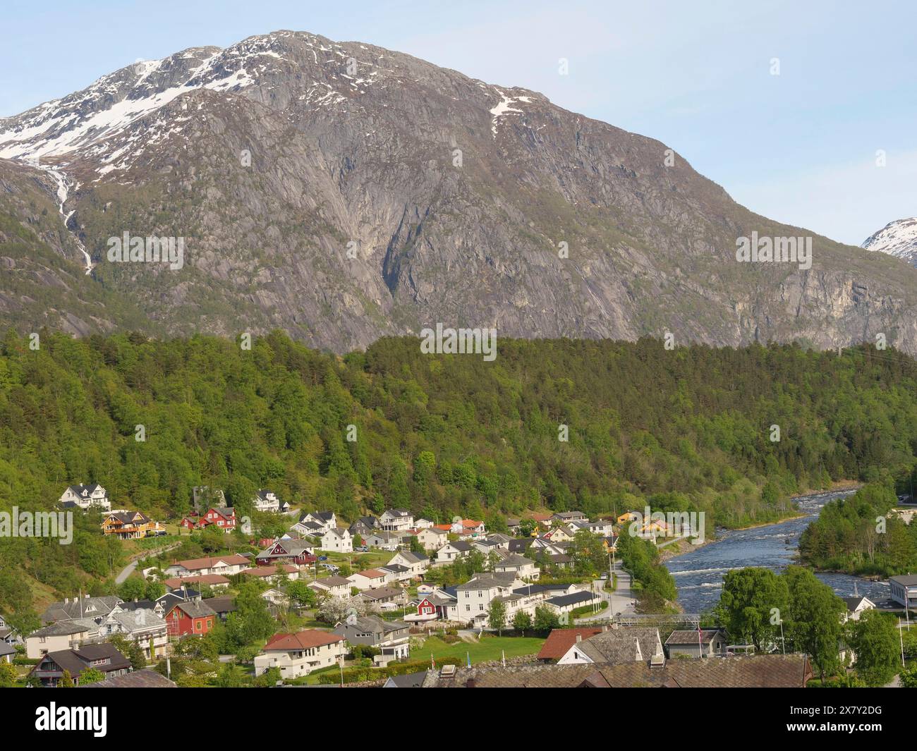 Riverside village surrounded by high mountains and dense forest, small ...