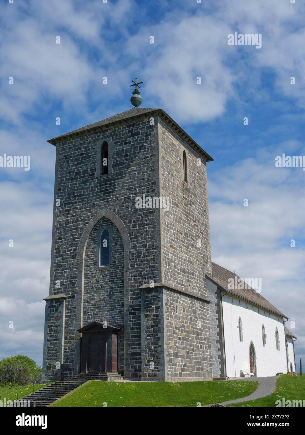 Old stone church stands alone under a partly cloudy sky, old stone ...