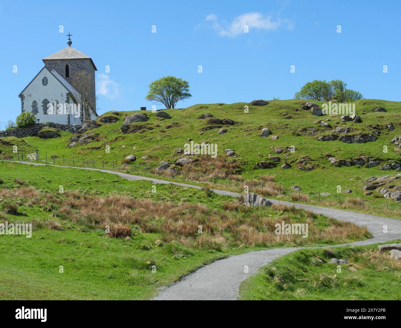 Church with hiking trail on hilly landscape, blue sky with clouds and ...