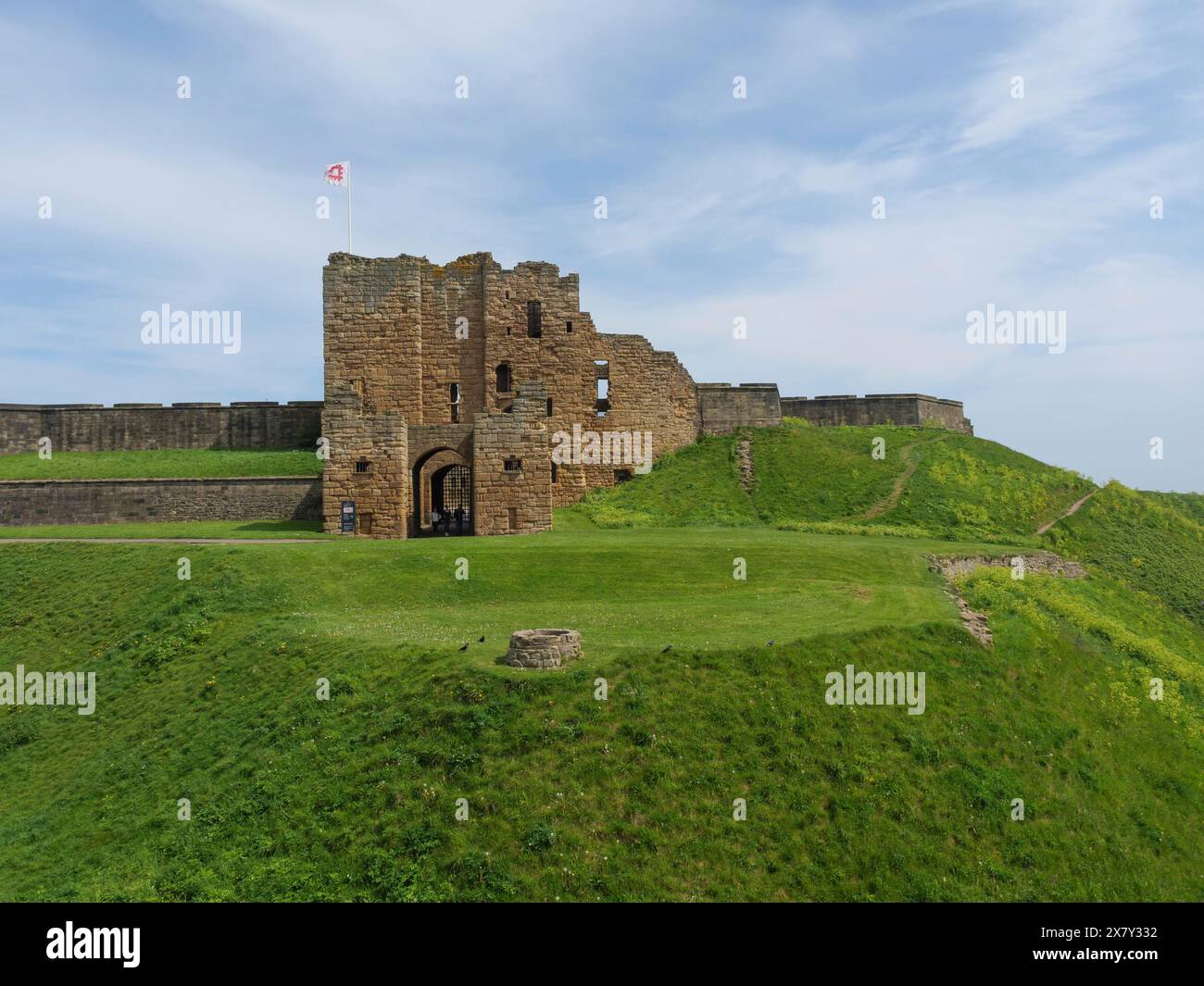 A medieval castle ruins building surrounded by green grass under a ...