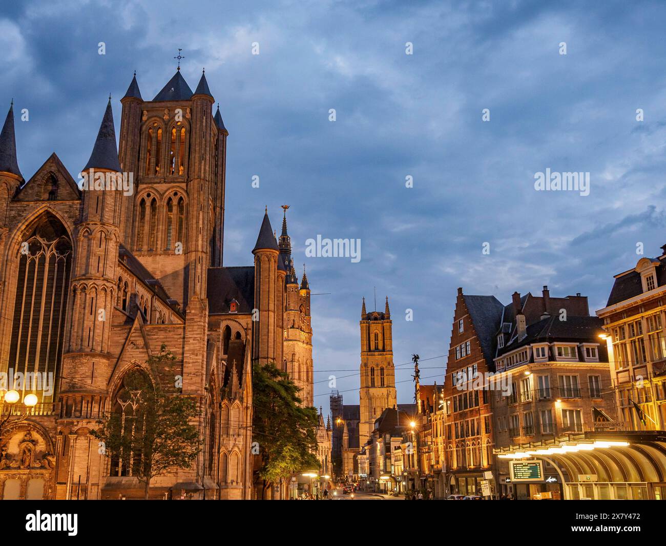 An illuminated gothic cathedral and towers in a historic city at night ...