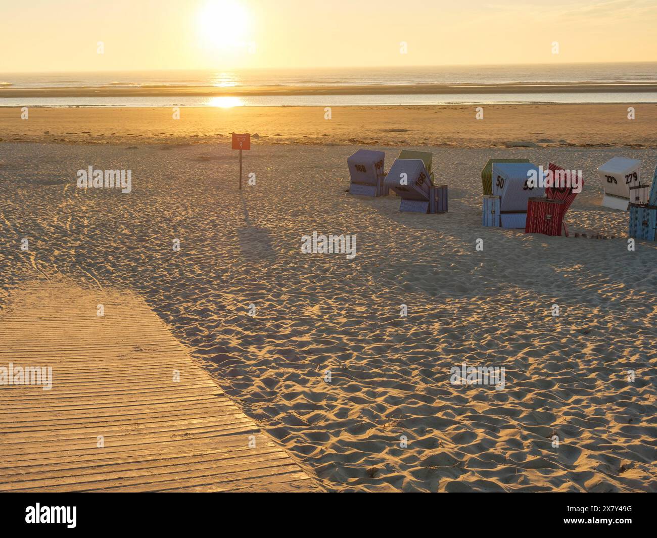 Beach with beach chairs and a sign in the sunset, peaceful and quiet ...
