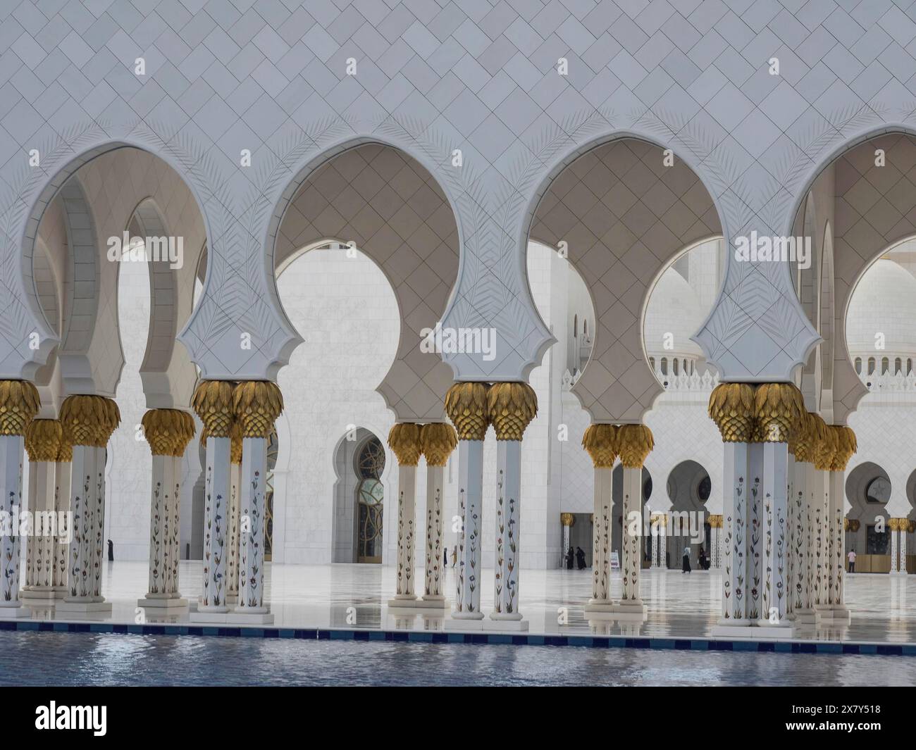 Arcades with golden decorations and white columns, Islamic architecture ...