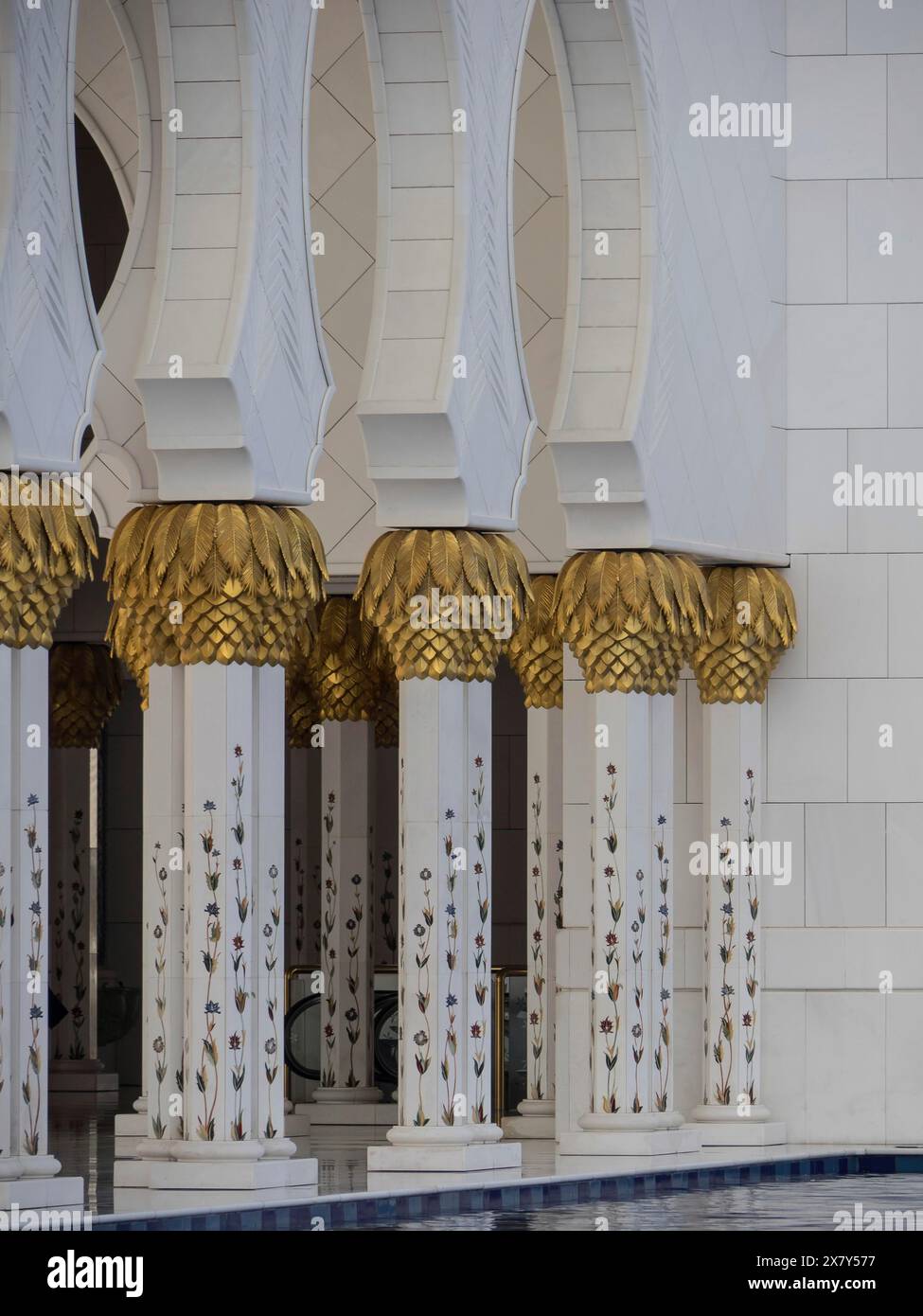 Columns with golden decorations and arches in the architectural ...