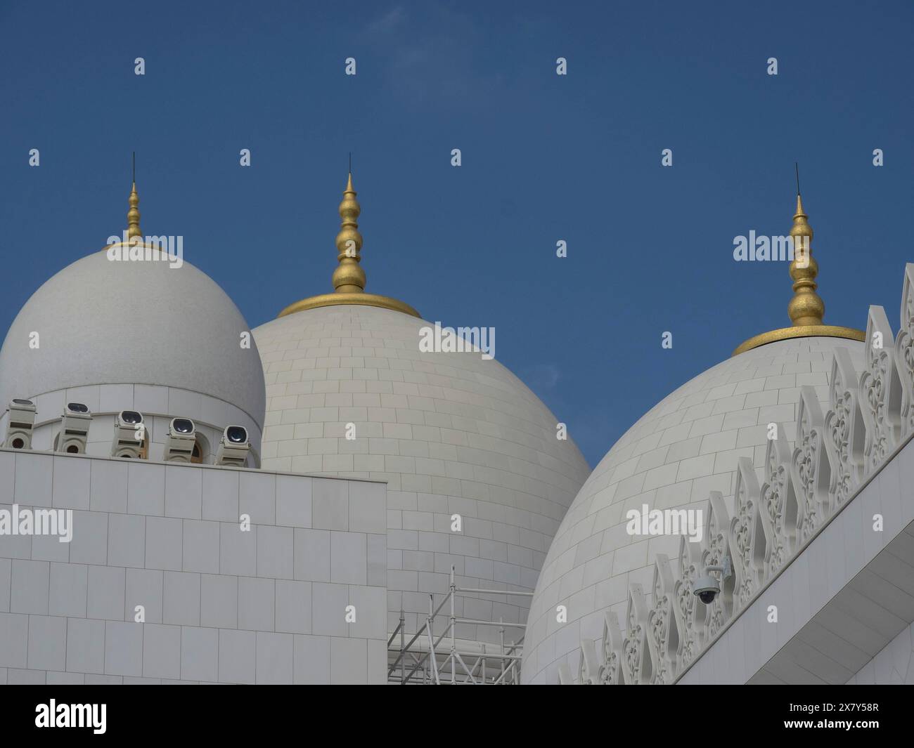 Detail of the white domes with golden tips under a deep blue sky, white ...