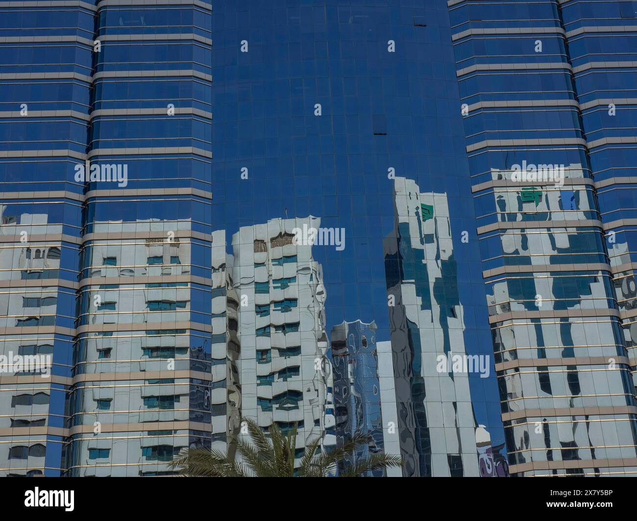 Reflective glass facades showing the mirror images of neighbouring high ...