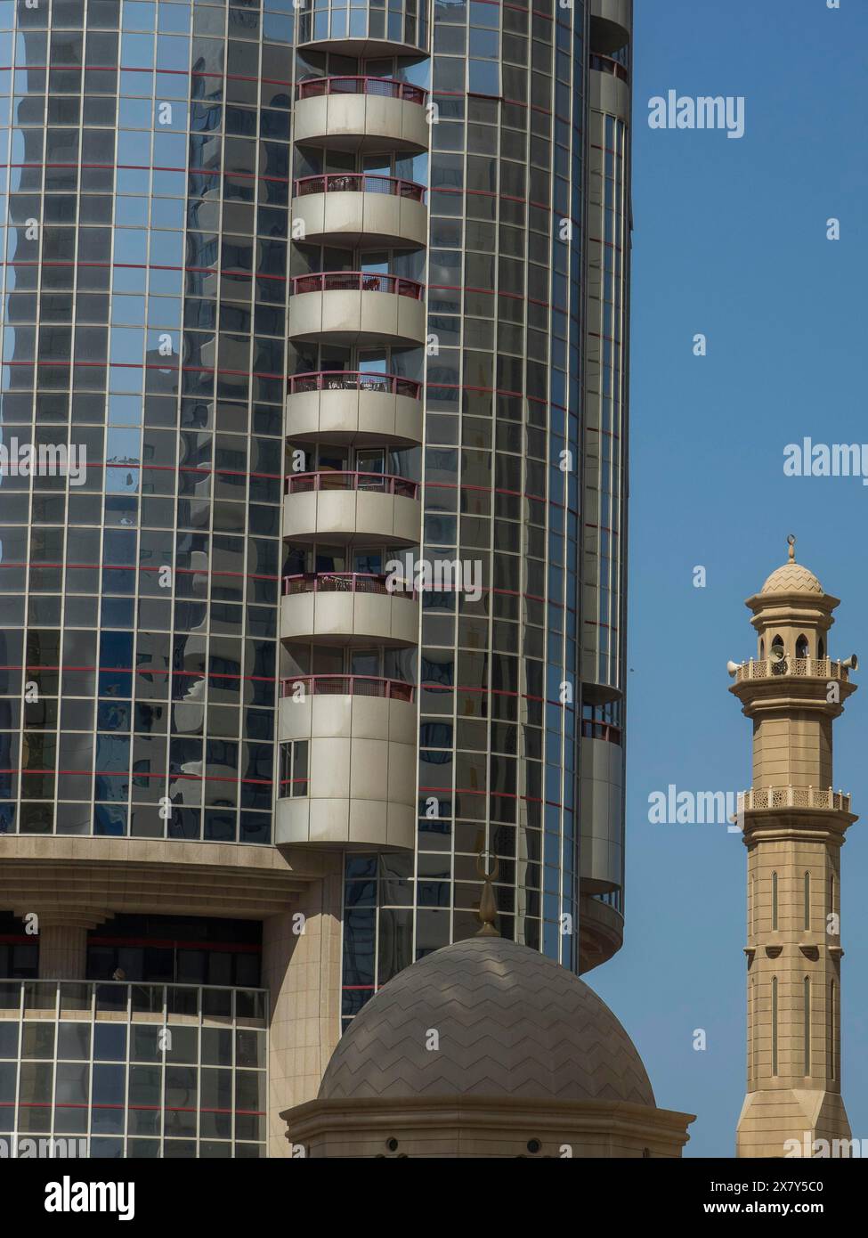 Tall modern buildings with glass facades next to a traditional ...