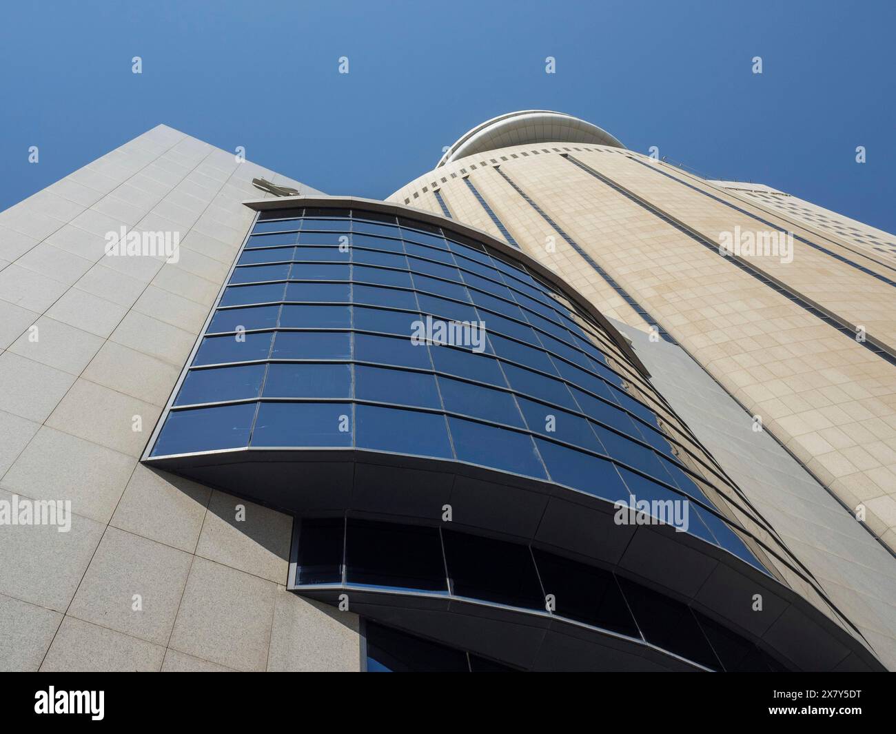 Modern buildings with glass windows rising against the clear blue sky ...