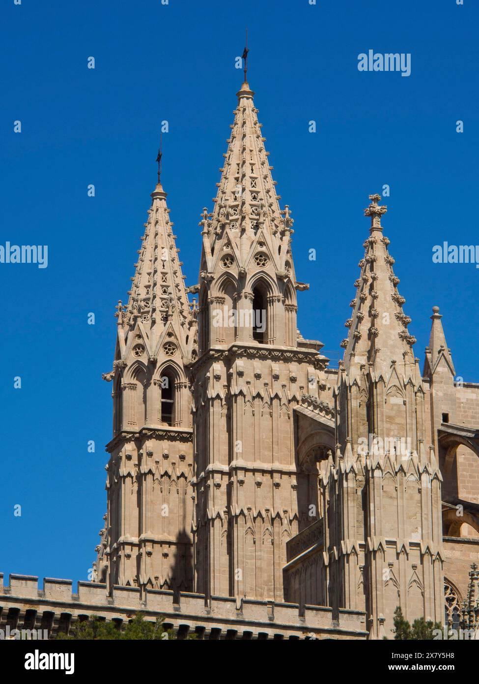 Two gothic towers of a cathedral under a clear blue sky, detailed ...