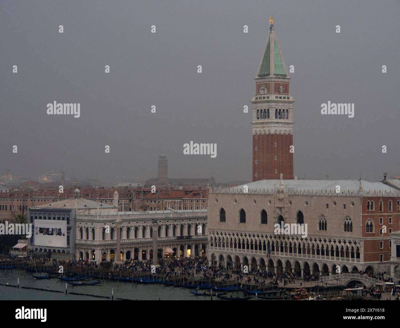 Campanile of Venice, surrounded by historic buildings, under a misty ...