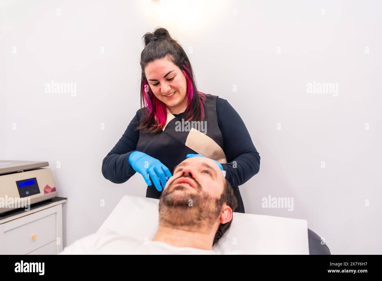 Man receiving a plasma injection as a treatment for the capillary zone ...