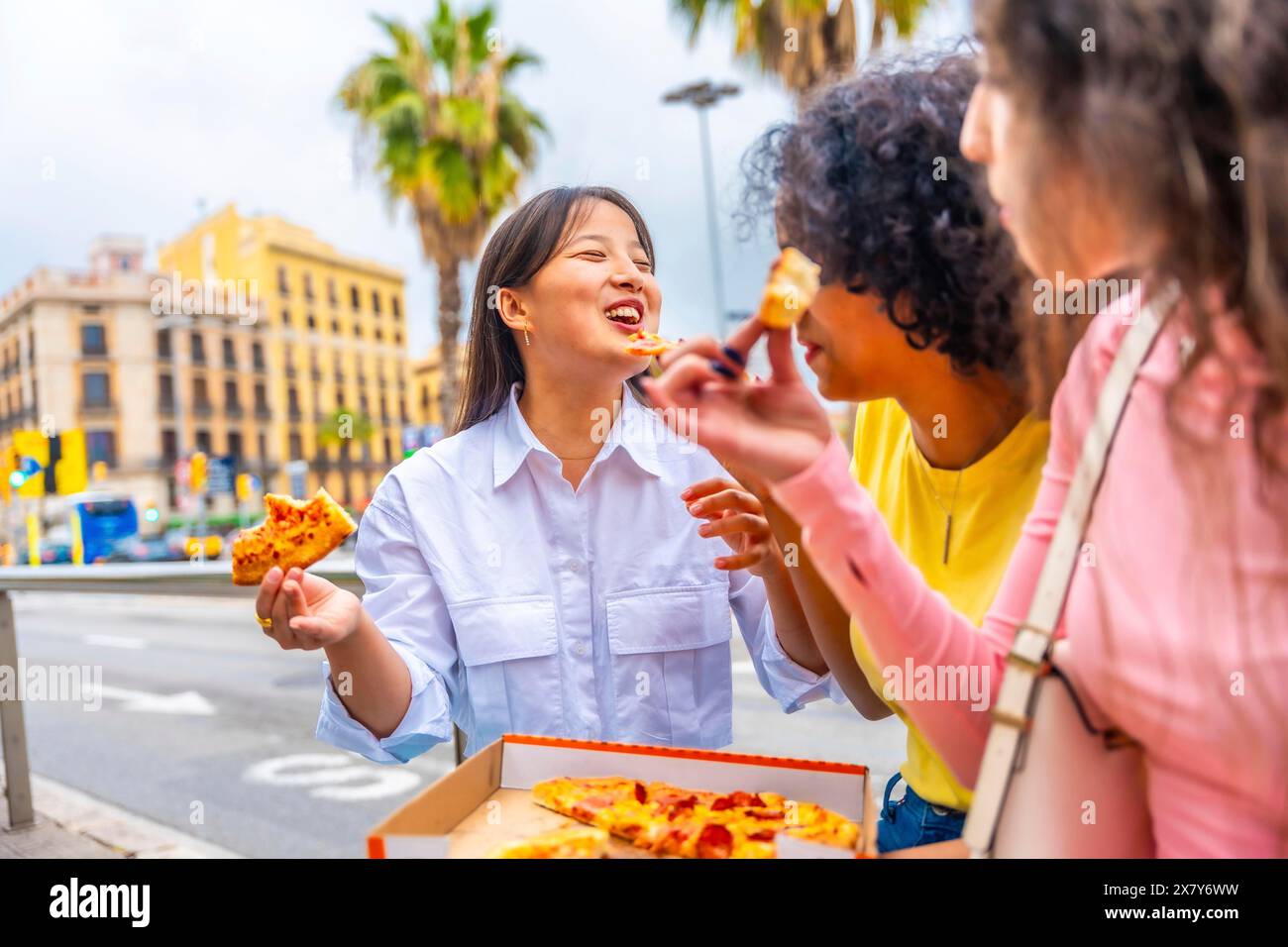 Young friends eating pizza chatting hi-res stock photography and images ...