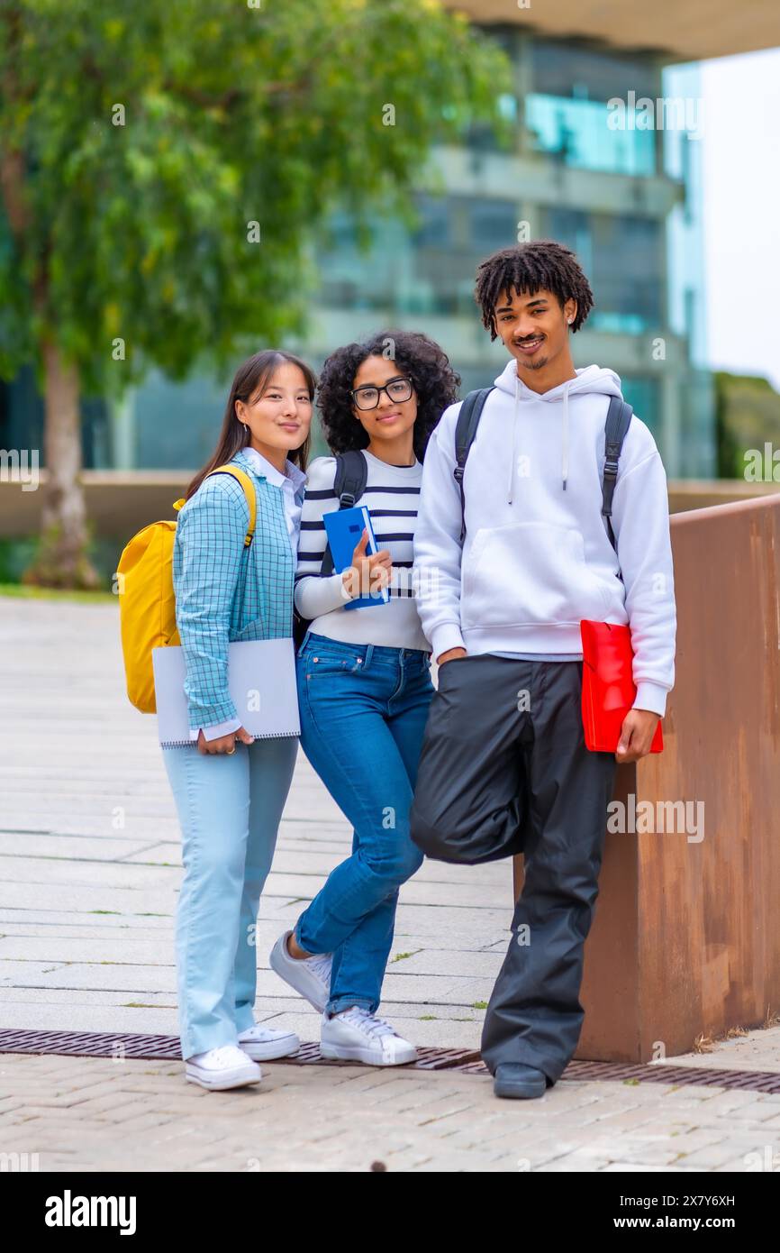 Vertical portrait of three multiracial university exchange students ...