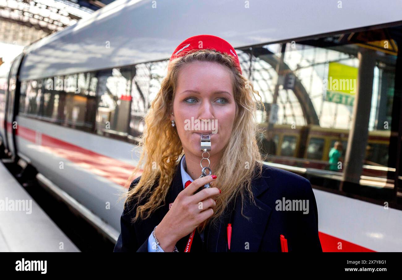 With a whistle, a Deutsche Bahn employee gives the train driver the ...