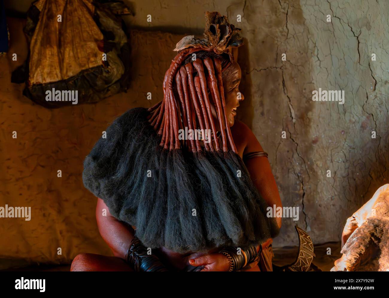 Traditional Himba woman shows her traditional hairstyle, near Opuwo ...
