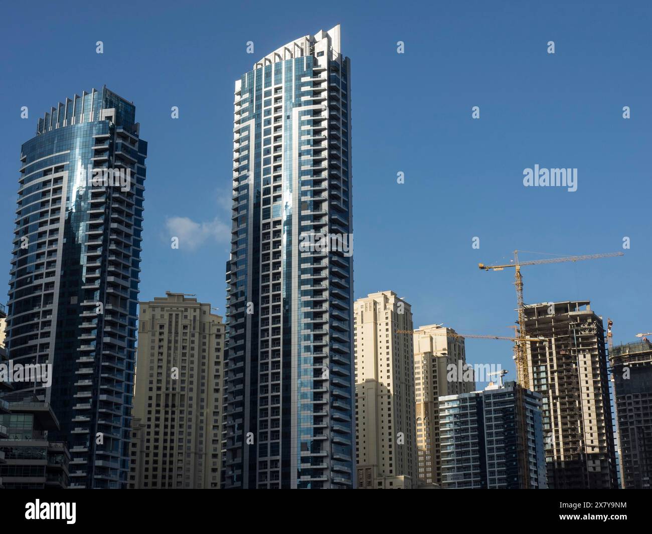 Several modern skyscrapers rise into the clear sky, some buildings ...