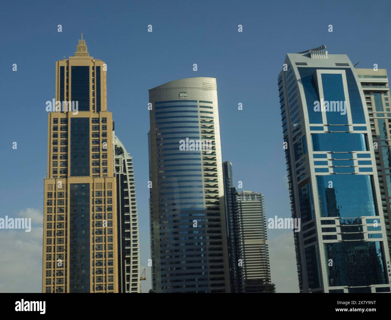 Three different skyscrapers with modern glass facades stand side by ...