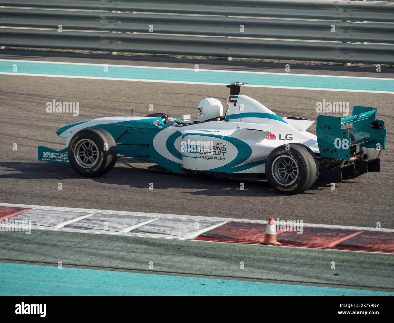 A Formula 1 racing car on a winding asphalt track, drivers focussed on ...