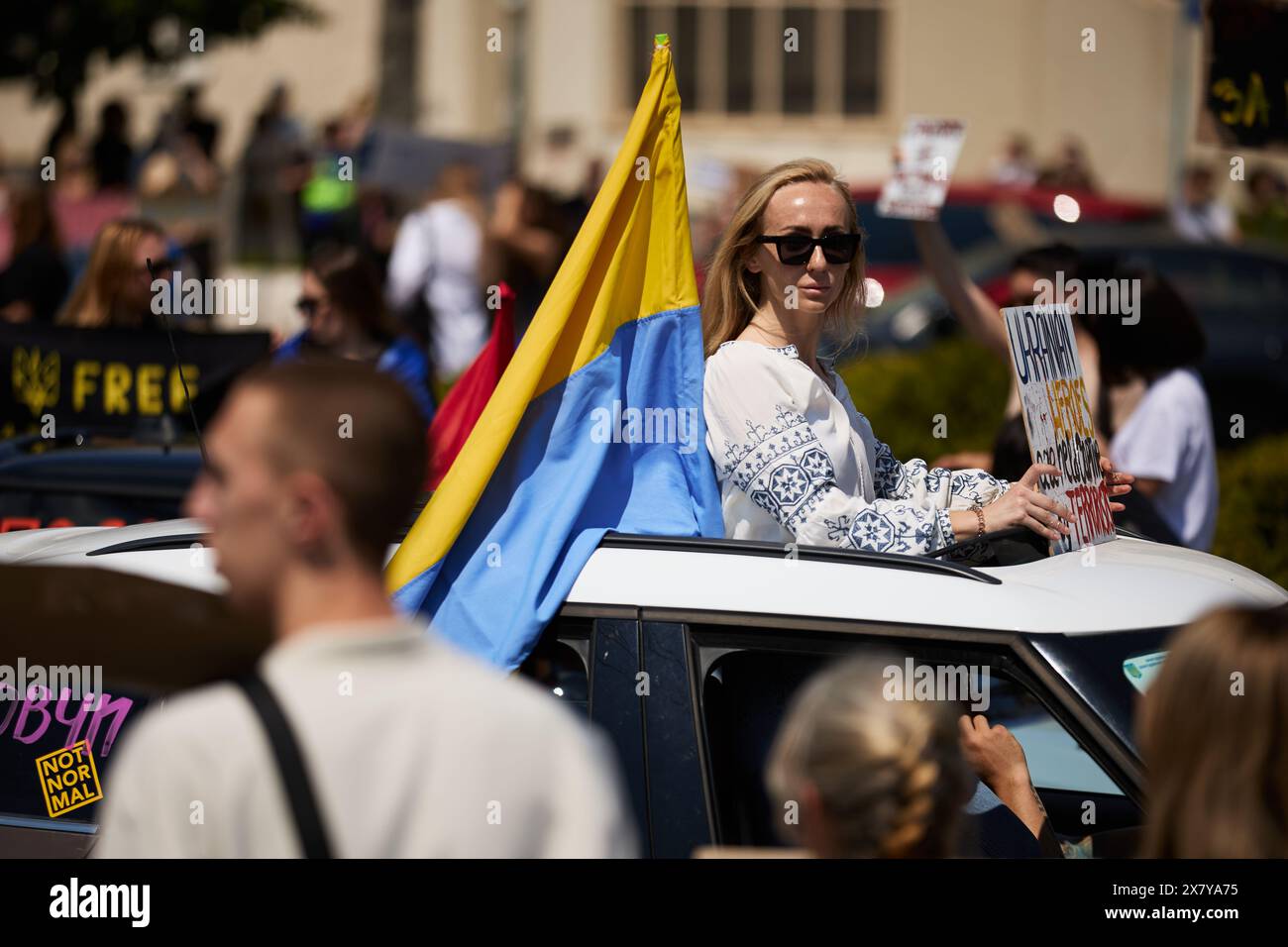 Young Ukrainian woman wearing traditional vyshyvanka shirt rides in a ...