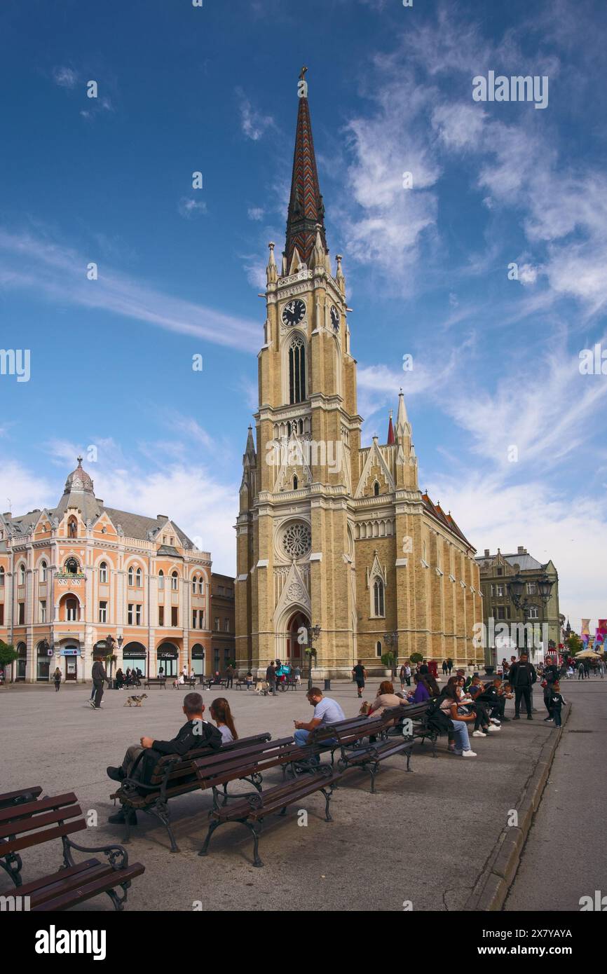 benches and people in Liberty Square overlooked by the spire of Name of ...