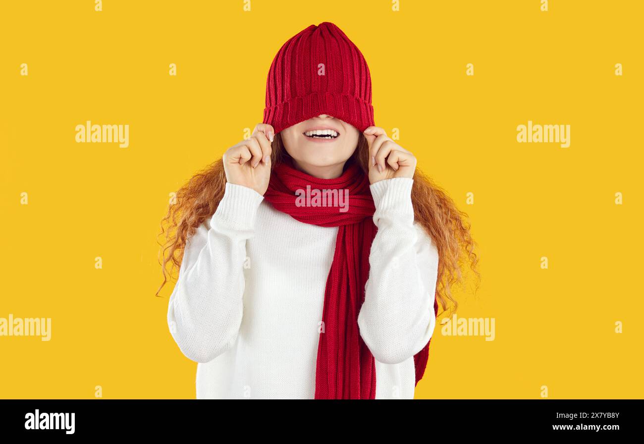 Funny teenage girl in scarf behaves cheerfully and playfully, pulling ... Funny teenage girl in scarf behaves cheerfully and playfully, pulling ...