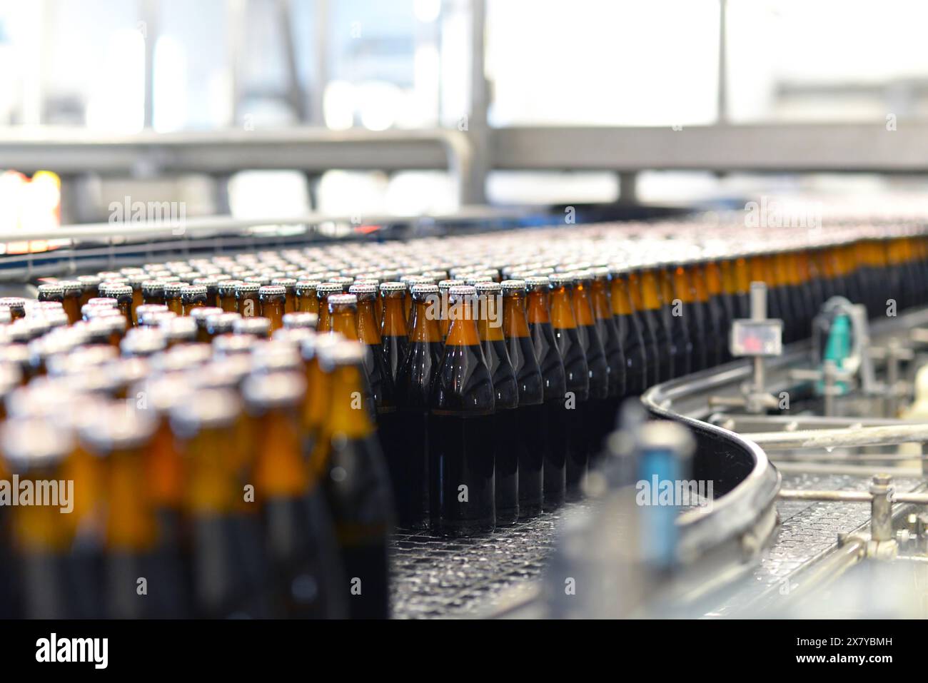 beer bottles on the assembly line in a modern brewery - industrial ...