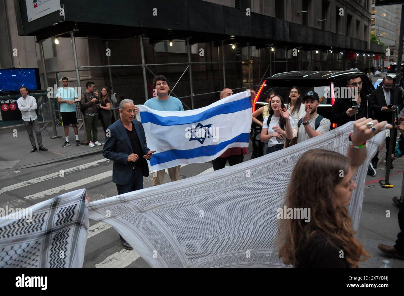 Israel supporters wave the Israeli flag near a pro-Palestine rally ...