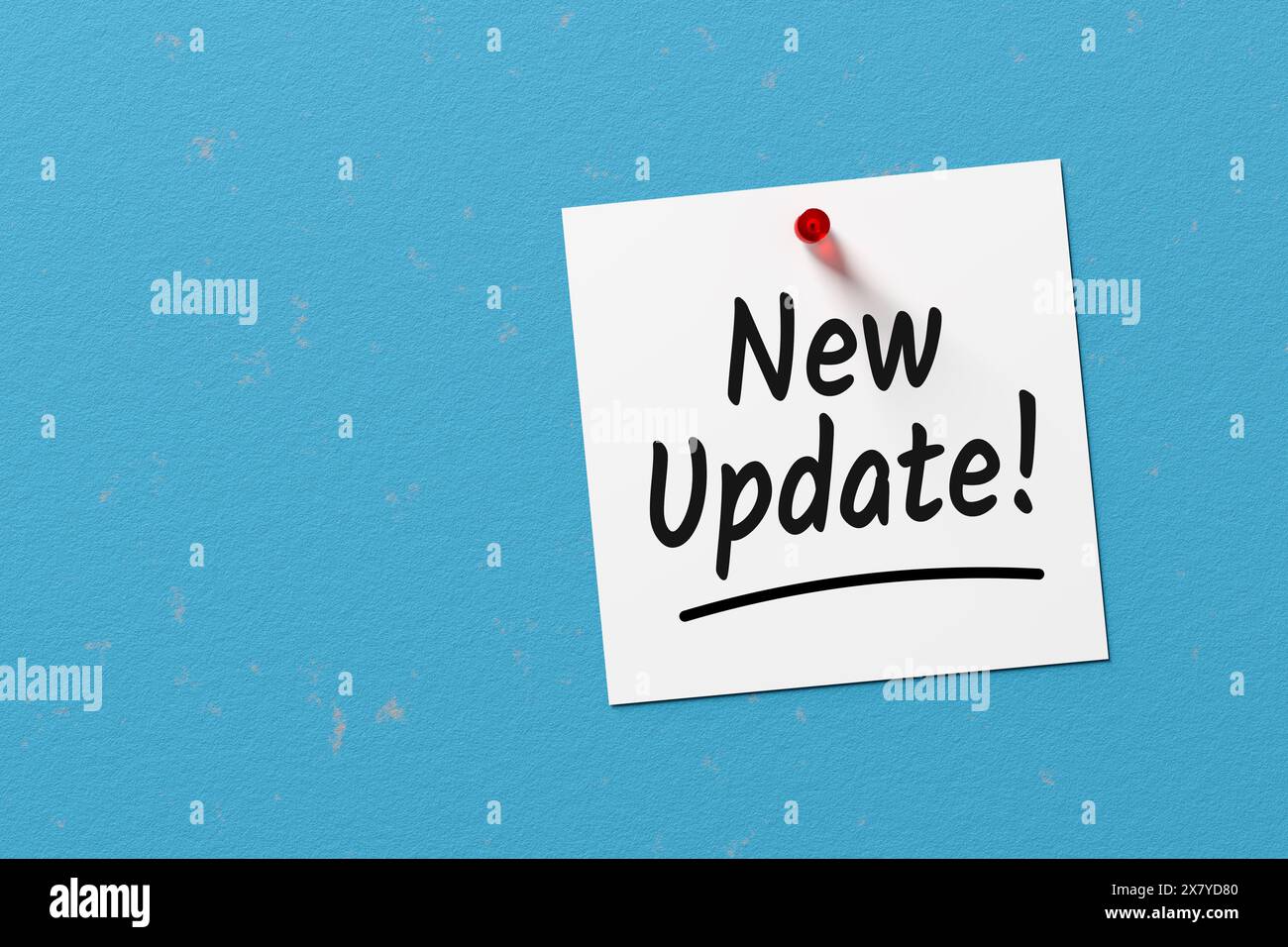 The message new update written on a note paper pinned on a blue ...