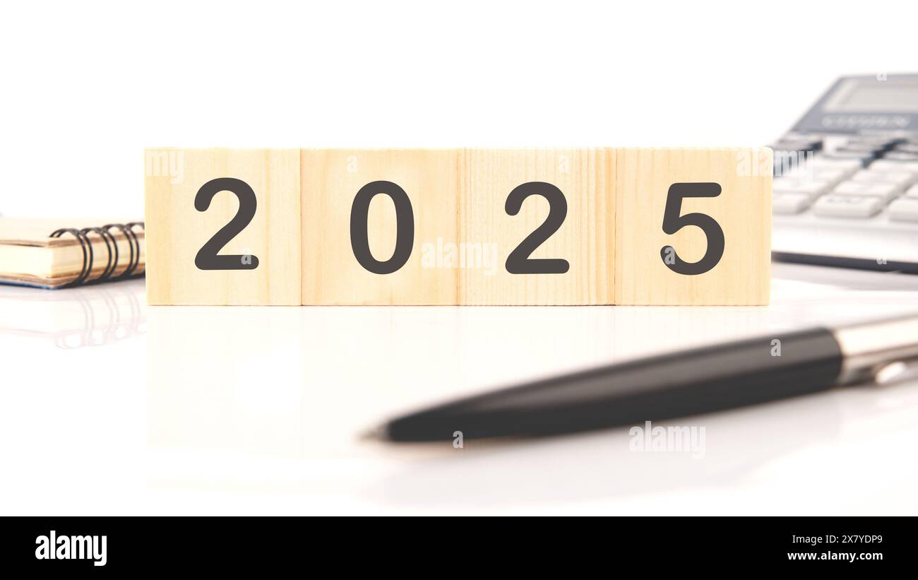 year 2025. 2025 written on wooden cubes in a composition with a ...